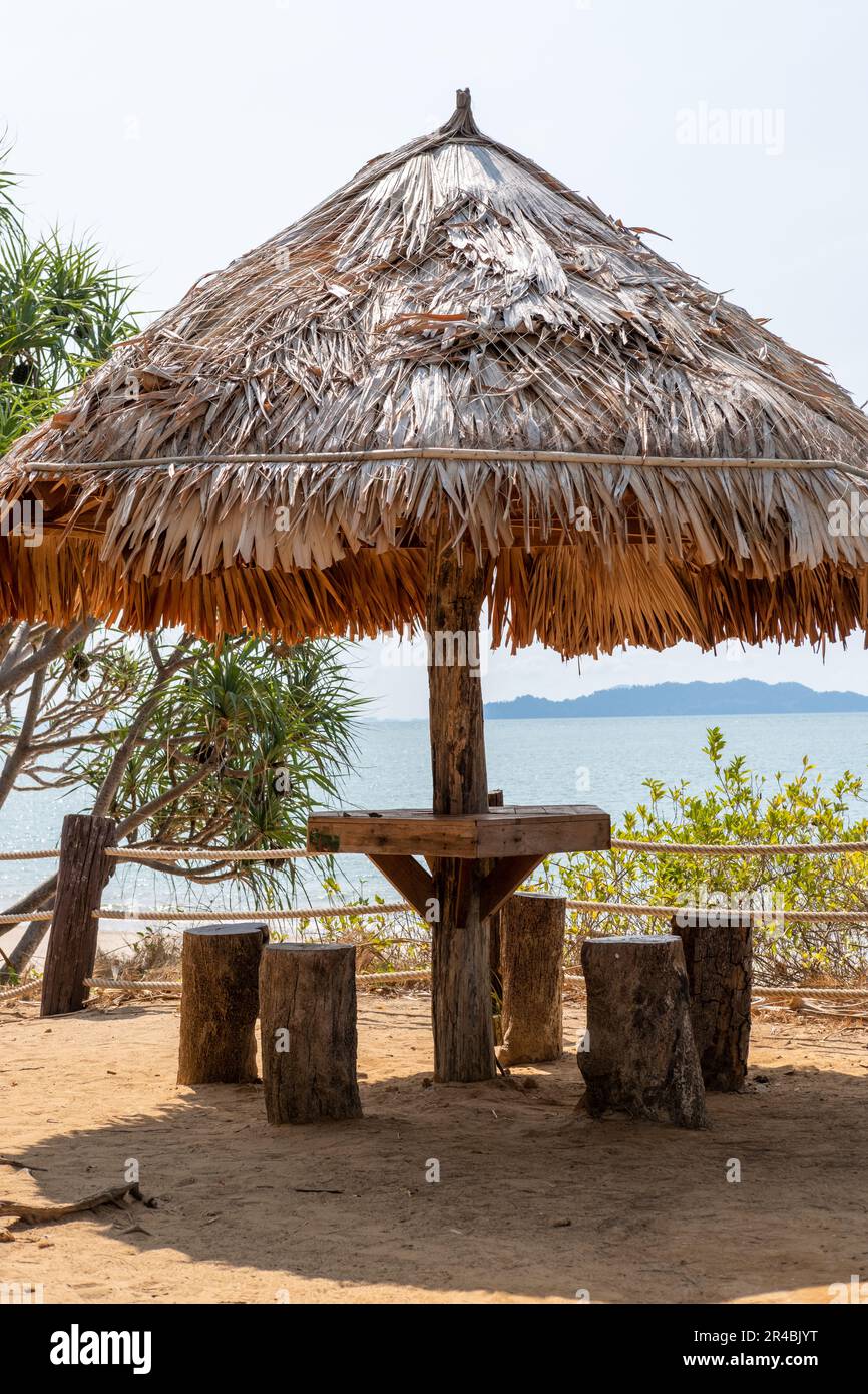 Seating under a wooden hut shelter, located by the sea Stock Photo - Alamy