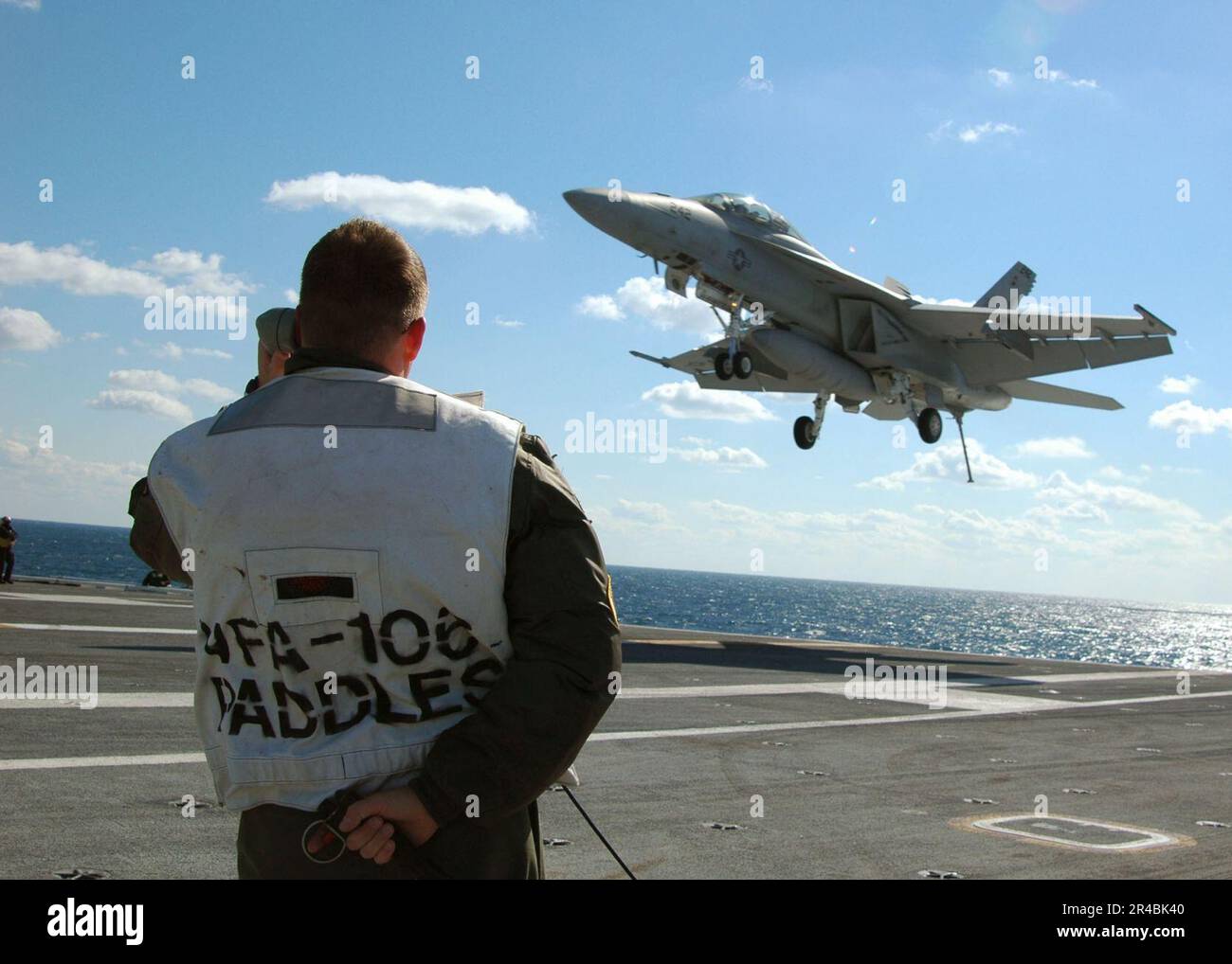 US Navy A Landing Signal Officer communicates with the pilot of an F-A ...
