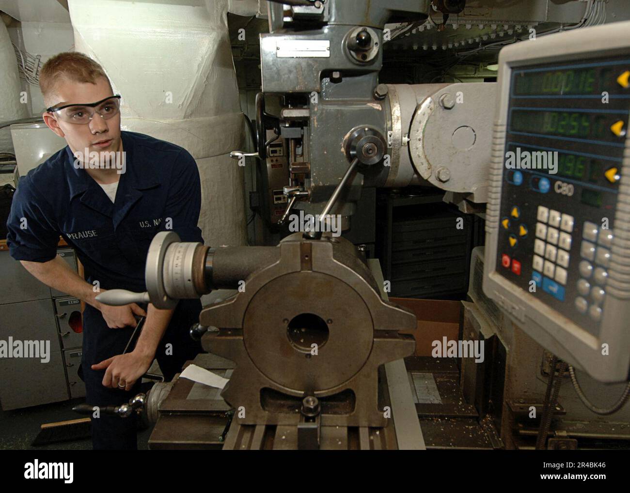 US Navy Machinery Repairman uses a milling machine to make a chuck key ...