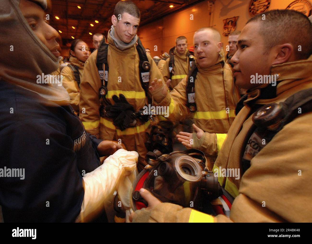 US Navy Sailors assigned to Repair Locker One Bravo discuss their ...