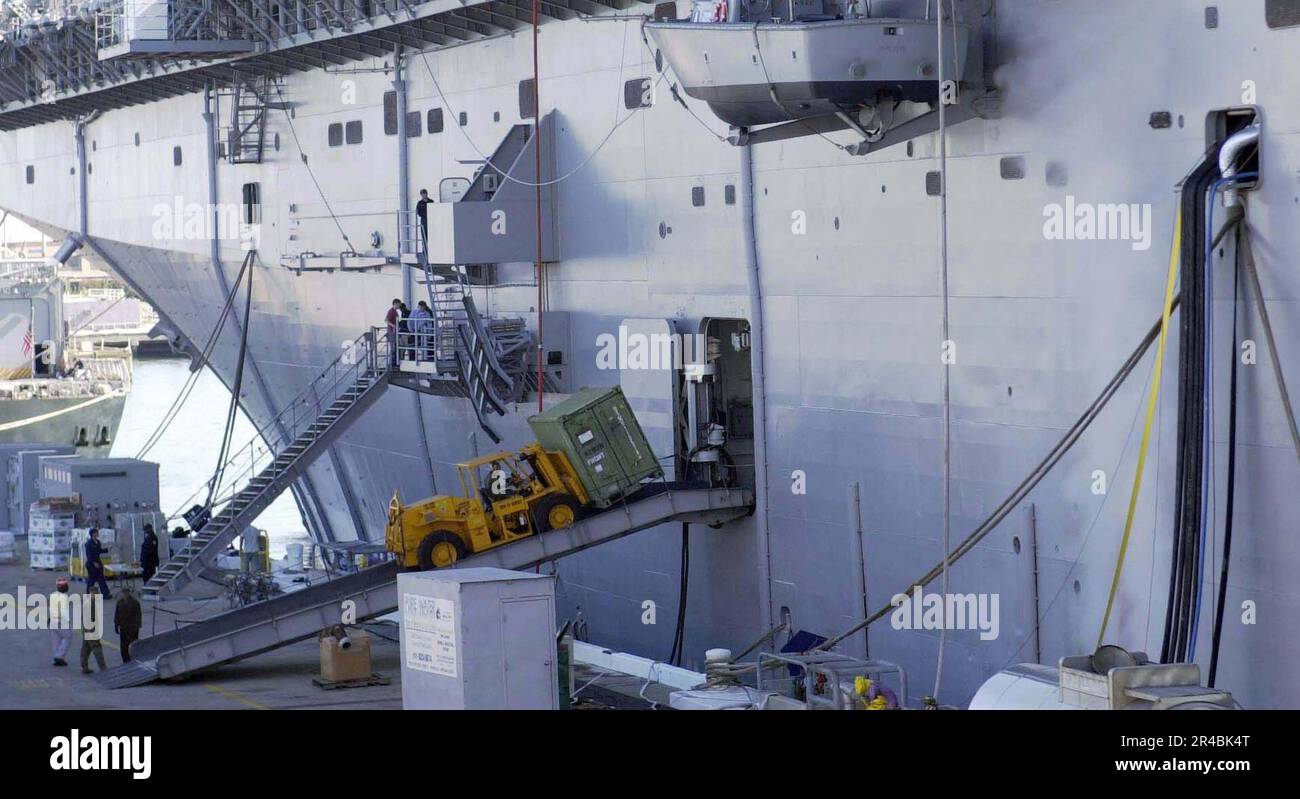 US Navy A forklift carries cargo into the amphibious assault ship USS ...