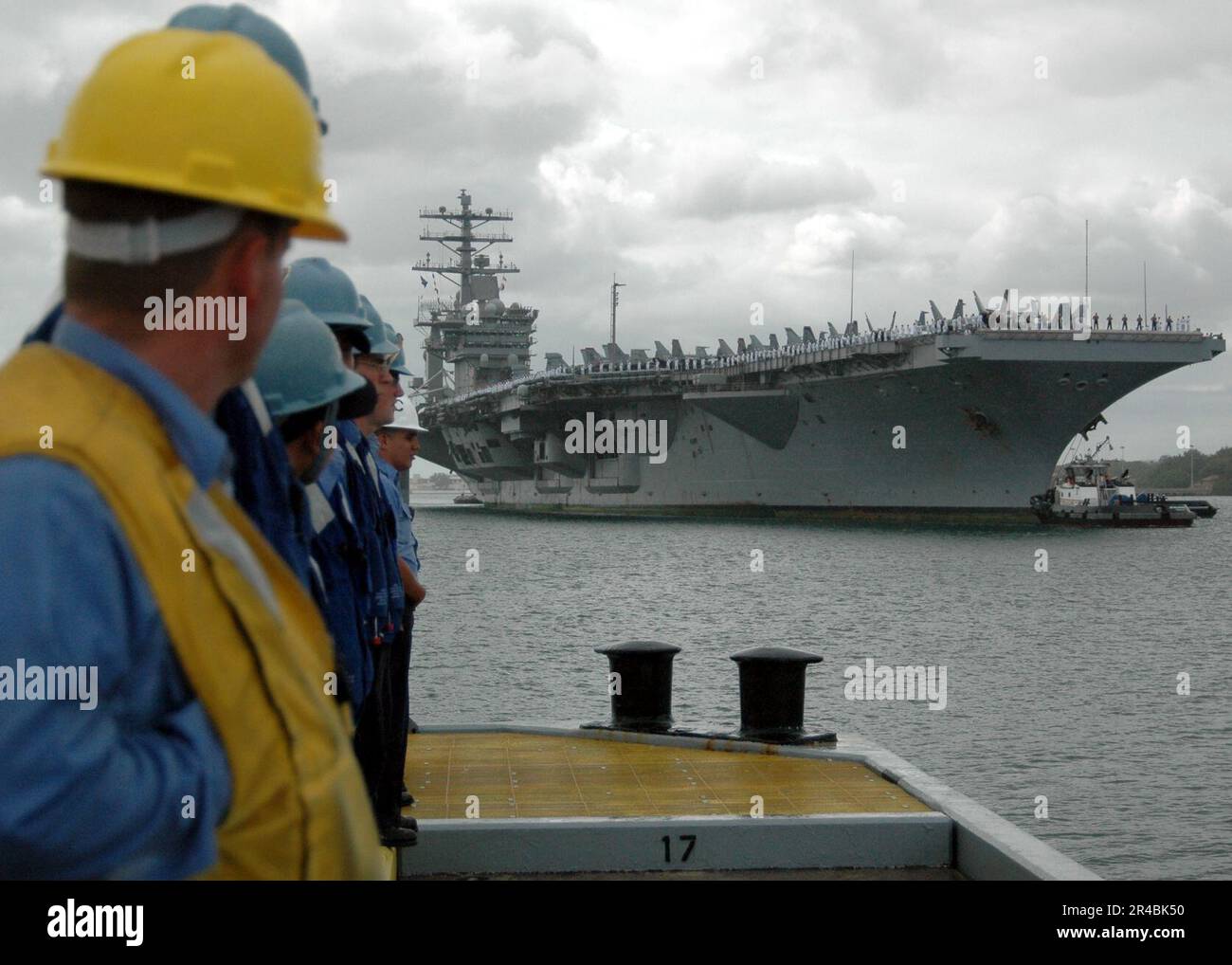 US Navy Line handlers assigned to Naval Station Pearl Harbor watch as ...