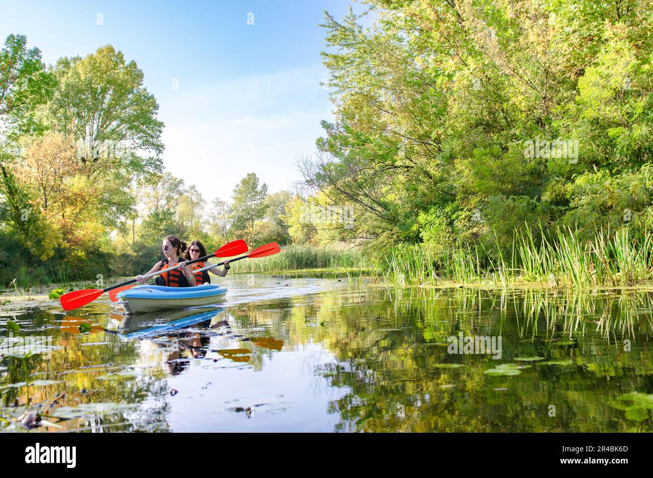 Family kayaking, mother and child paddling in kayak on river canoe tour ...