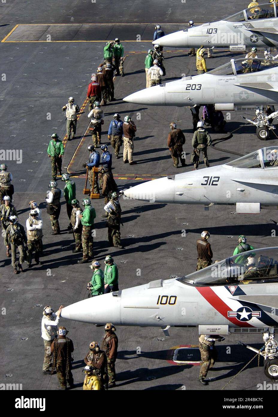 US Navy Squadron personnel prepare their aircraft for flight operations ...