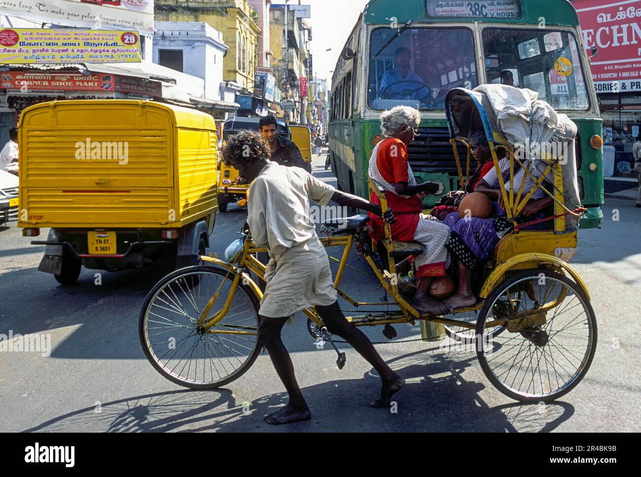 A cycle rickshaw crossing the road in Chennai, Tamil Nadu, India, Asia ...