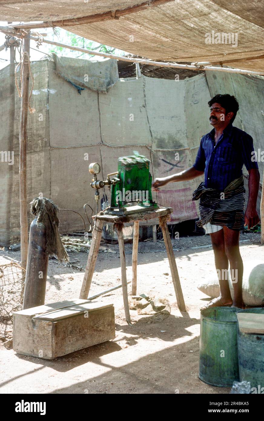 A man making soda, weekly Periodical market at Perundurai near Erode ...