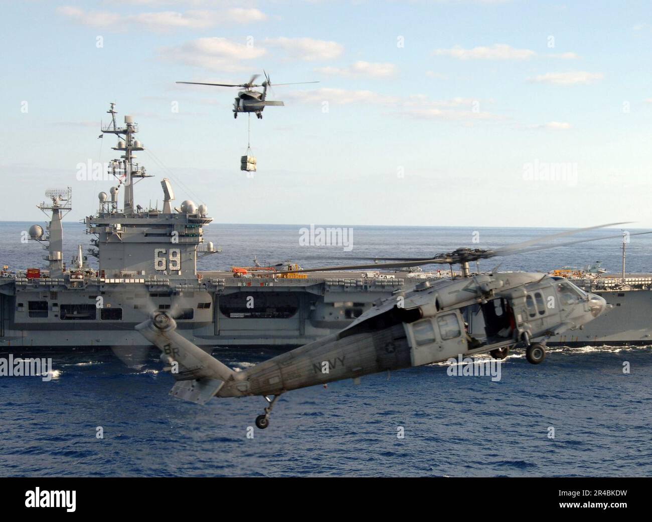 US Navy An MH-60S Seahawk helicopter hovers as another Seahawk ...