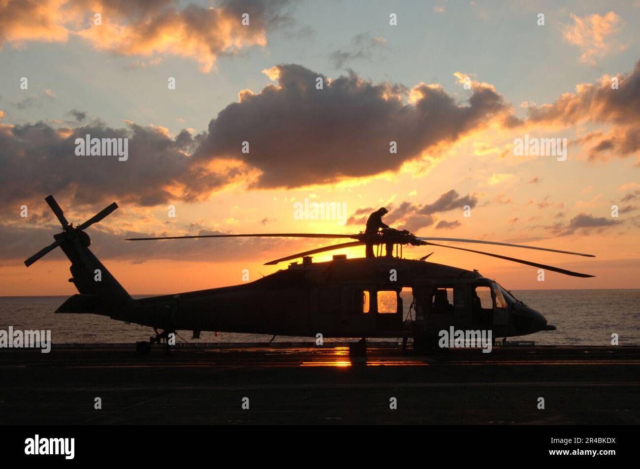 US Navy A Sailor performs maintenance on the rotorhead of an MH-60S ...