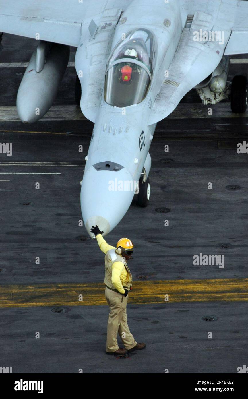 US Navy Flight Deck Officer, Lt. monitors the movement of flight deck ...