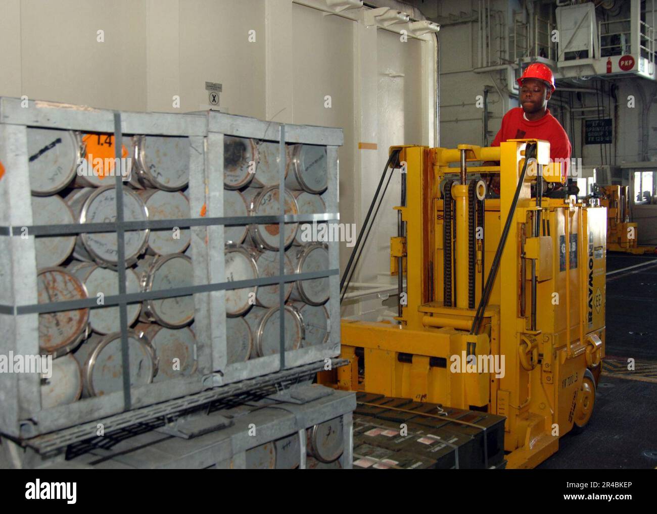 US Navy Aviation Ordnanceman Airman transports ordnance through the ...