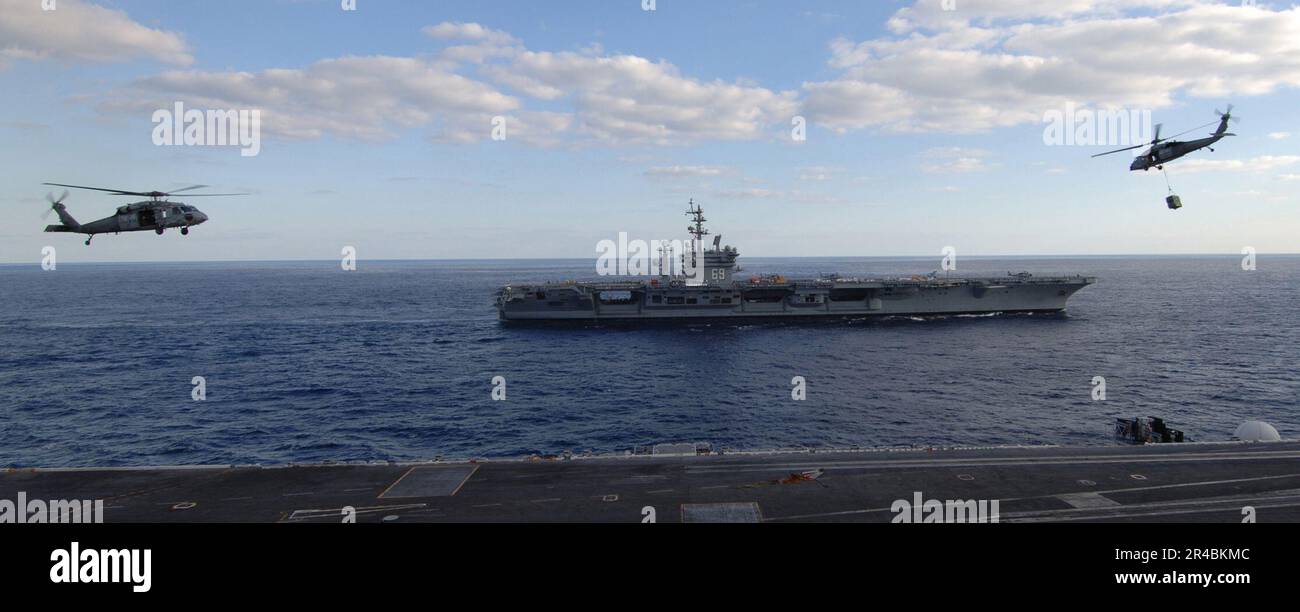 US Navy Two MH-60S Seahawk helicopters lift ammunition off the flight ...
