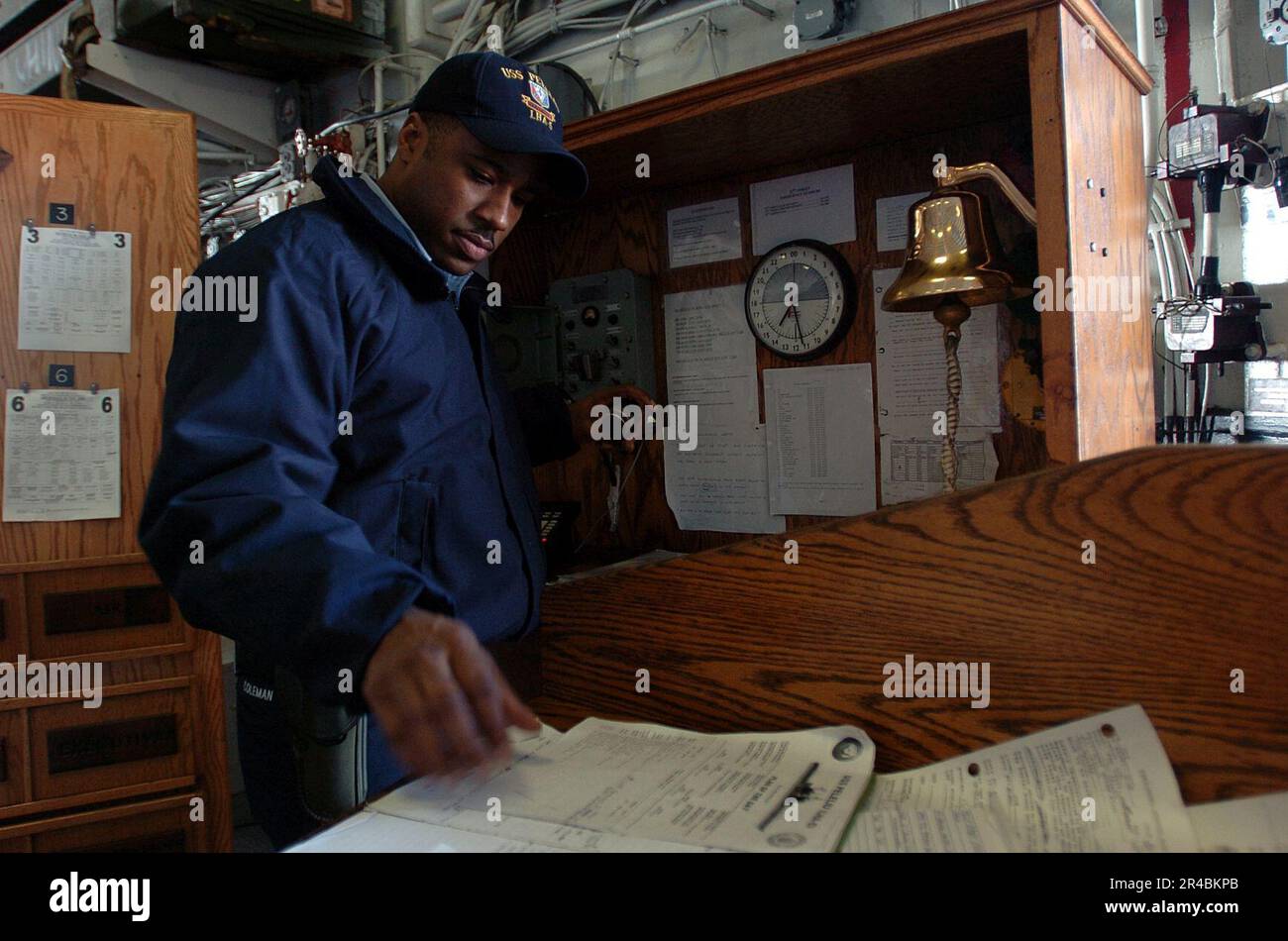 US Navy Store Keeper 2nd Class prepares to make an announcement over ...