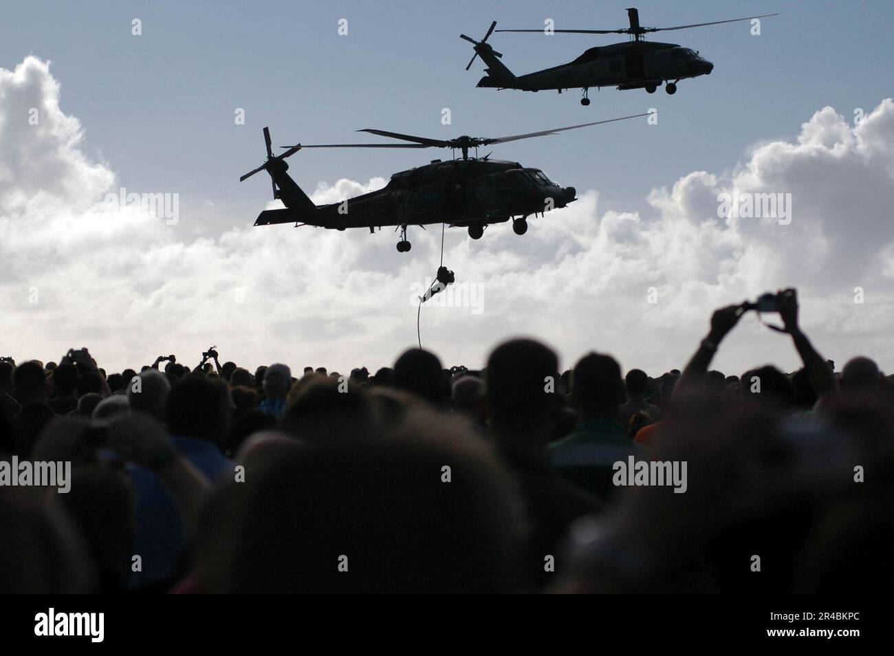 US Navy Crew members, friends and family watch as an HH-60H and an SH ...