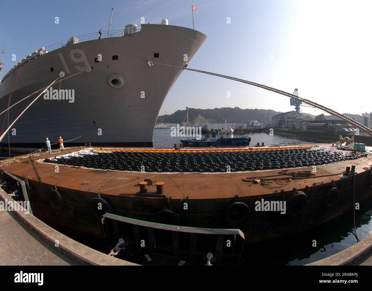 US Navy A barge is transferred alongside the command ship USS Blue ...