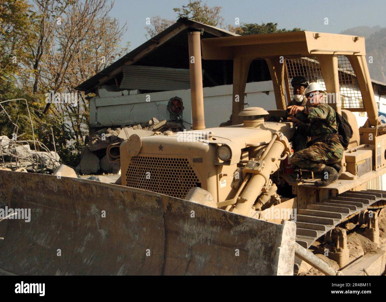 US Navy U.S. Navy Senior Chief Construction Mechanic right, instructs ...