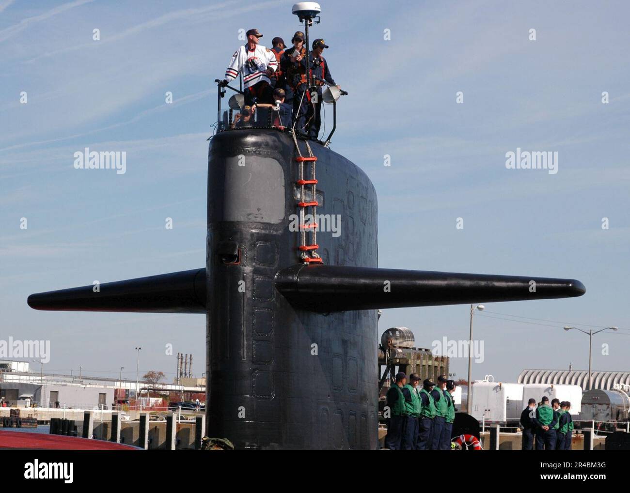 US Navy Commanding Officer, USS Norfolk (SSN 714), Cmdr. center, looks ...