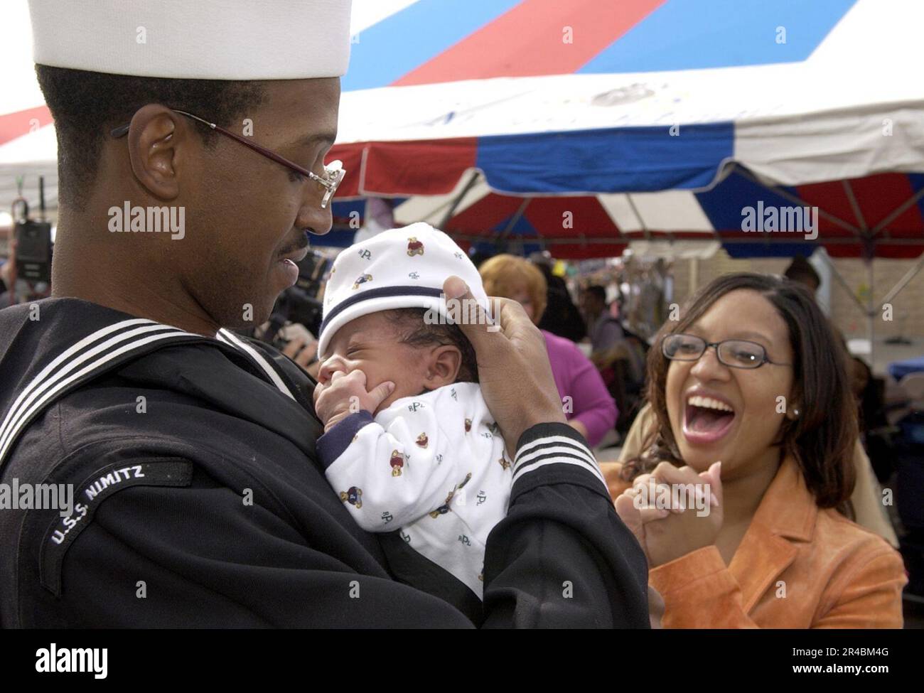 US Navy Aviation Boatswain's Mate Seaman is greeted excitedly by his ...