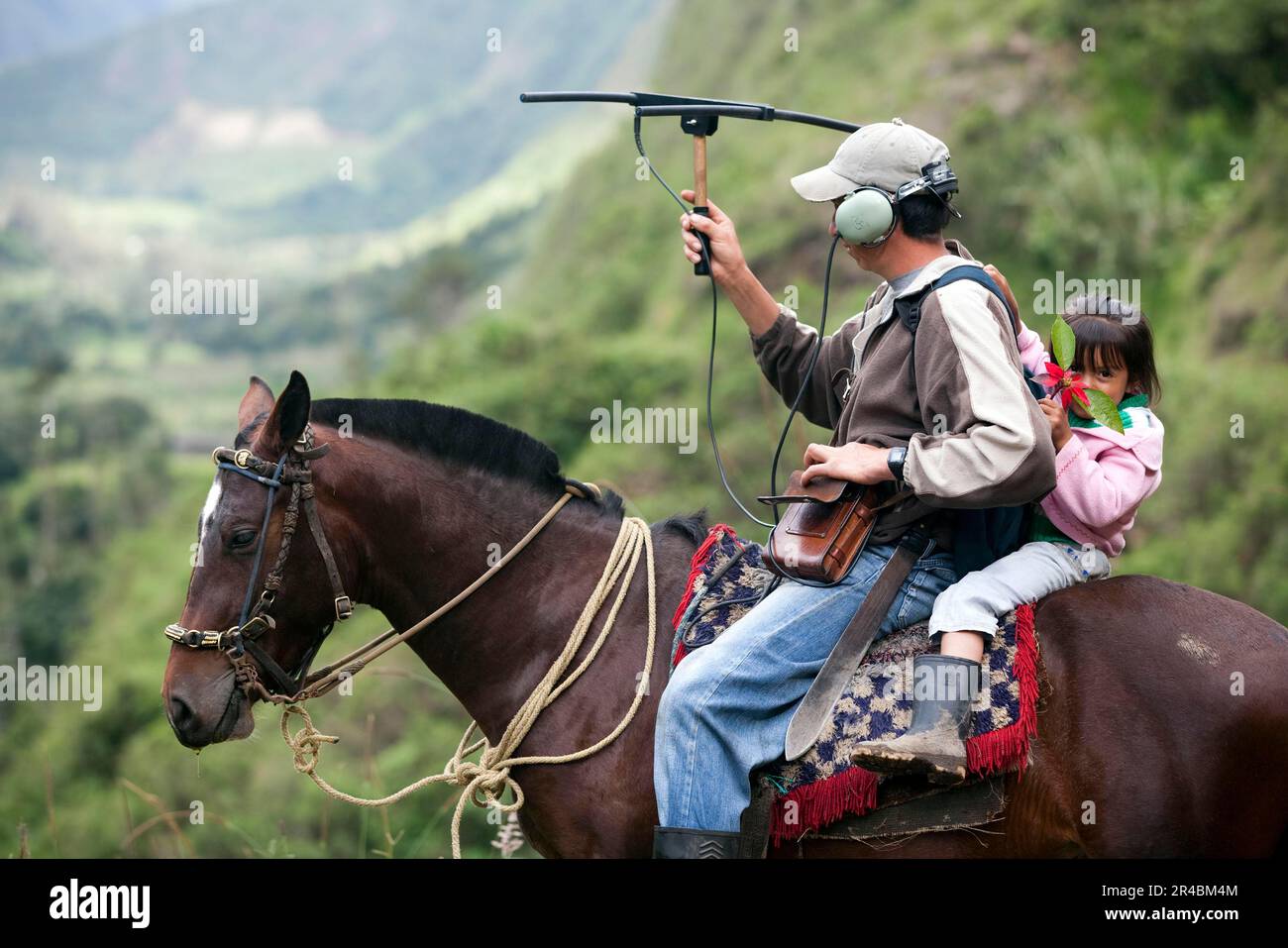 Biologist tracking spectacled bear with radio antenna, conservation ...