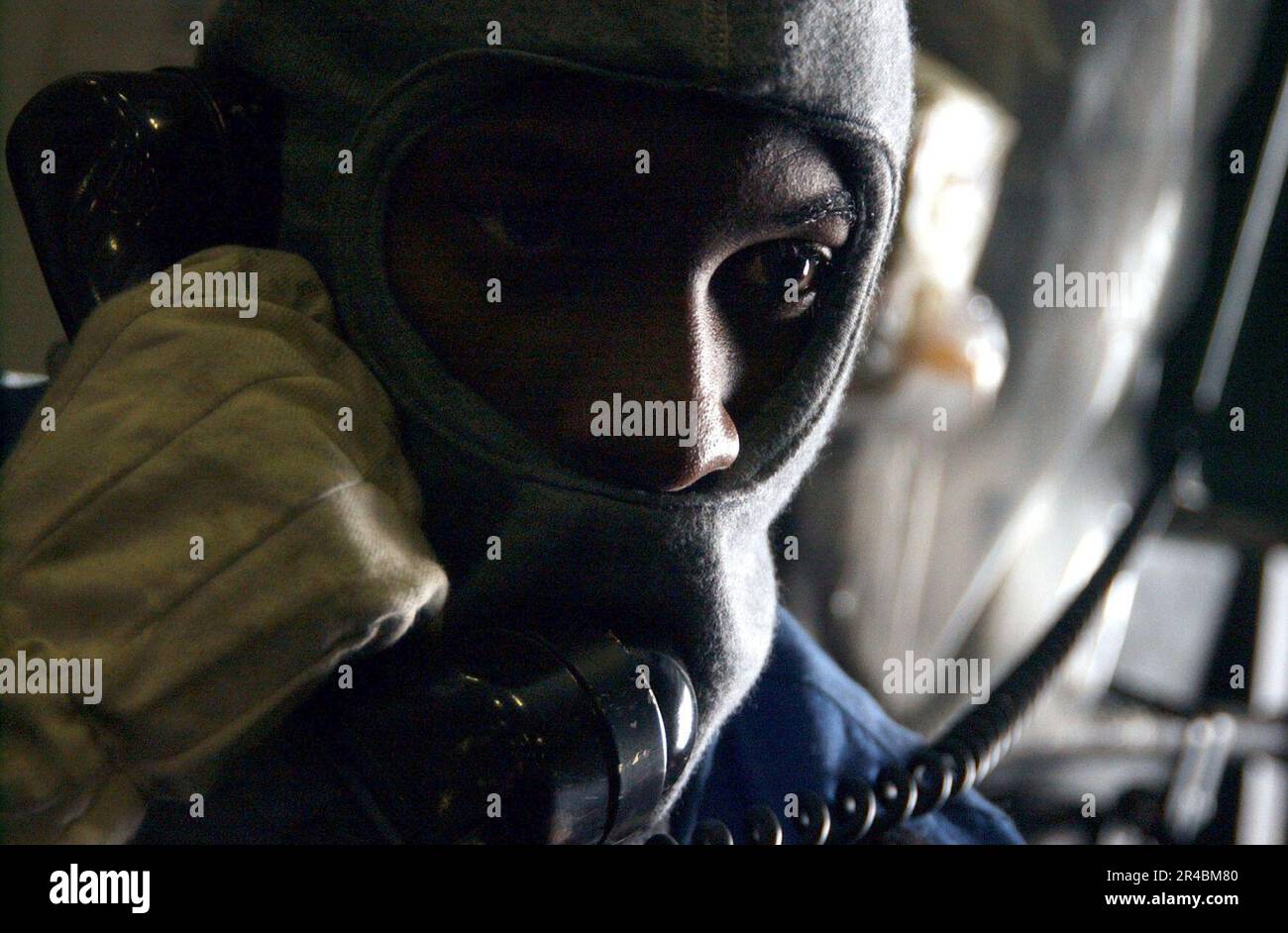 US Navy Airman communicates on a sound powered telephone during a fire ...
