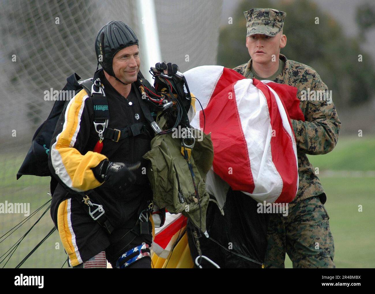 US Navy U.S. Army Retiree, Sgt. 1st Class left, is helped with his ...