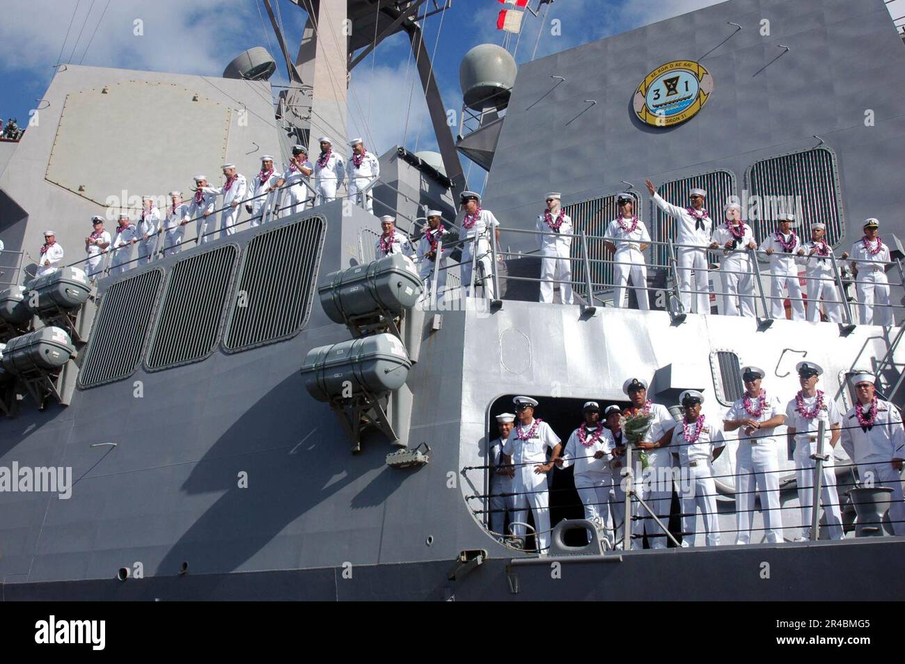 US Navy Sailors man the rails aboard the guided missile destroyer USS ...