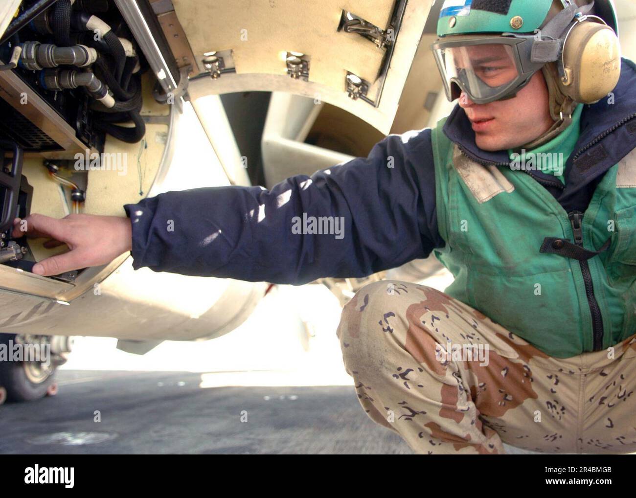 US Navy Photographer's Mate 3rd Class inserts a maintenance data card ...