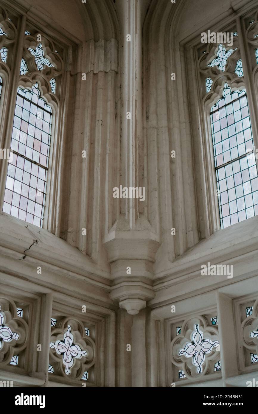 An ornate gothic-style building with a set of stained glass windows ...