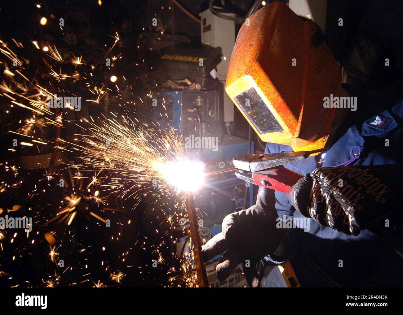 US Navy Hull Technician 3rd Class practices cutting metal using a ...