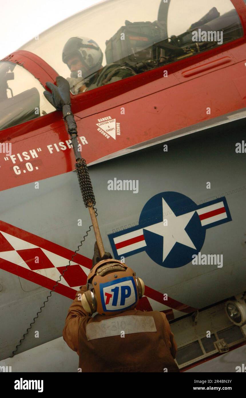 US Navy A Plane Captain applies an electro-static discharge ''hand'' to ...