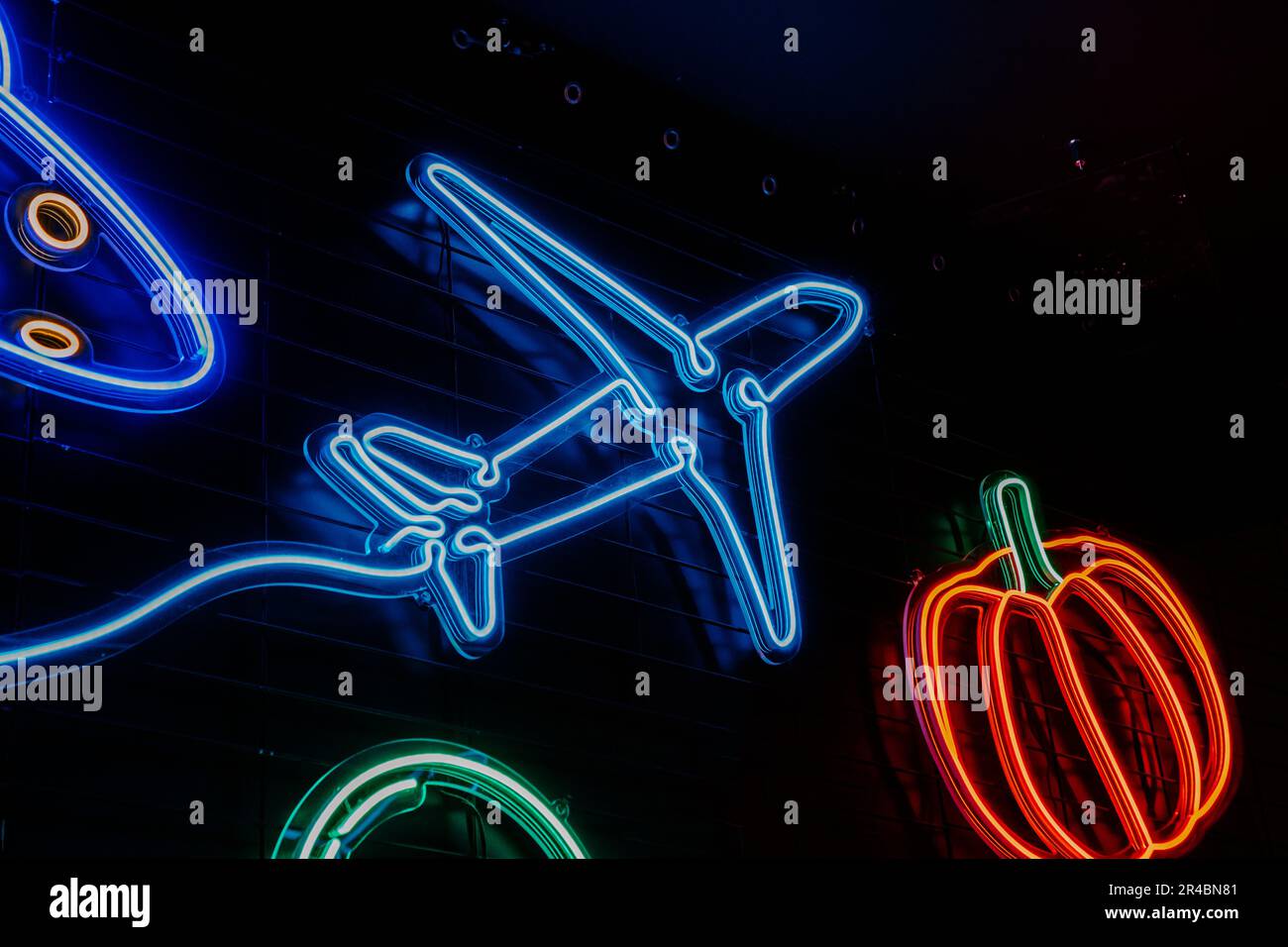 A vibrant, colorful wall display with neon lights, signs of an aircraft ...