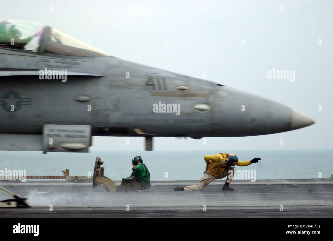 US Navy A catapult shooter gives the signal to launch as an F-A-18C ...