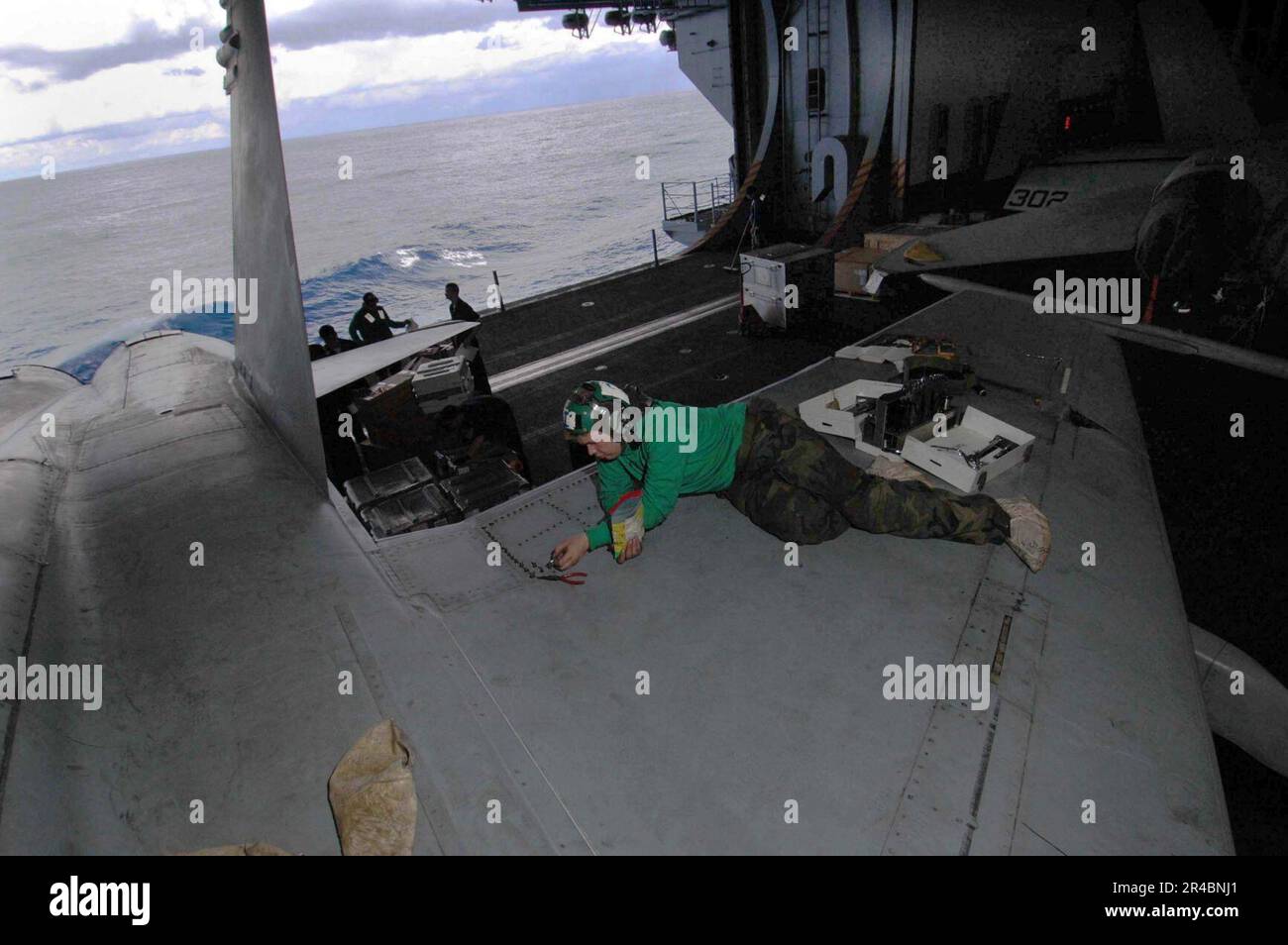 US Navy Aviation Electronics Technician 3rd Class repairs a missile ...