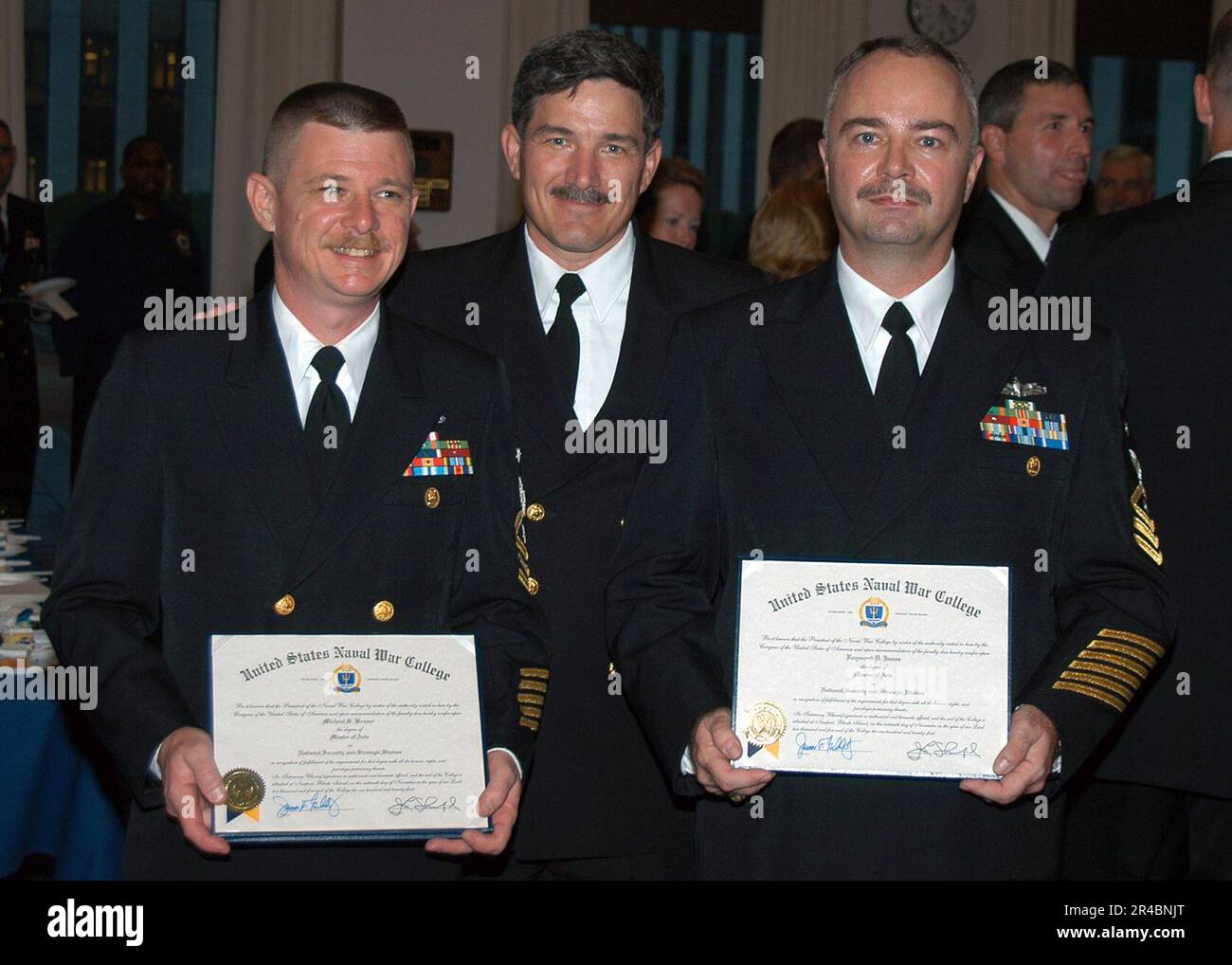 US Navy Master Chief Petty of the Navy Terry Scott, center ...