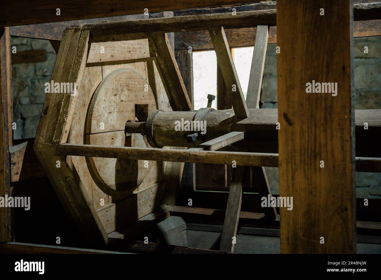 A vintage wooden grinder in a dimly lit room Stock Photo - Alamy