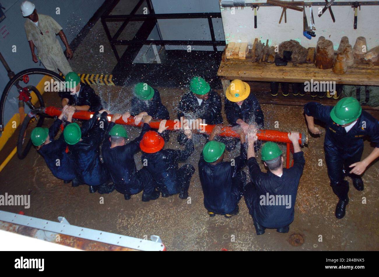 US Navy Students learn how to patch a pipe under simulated conditions ...