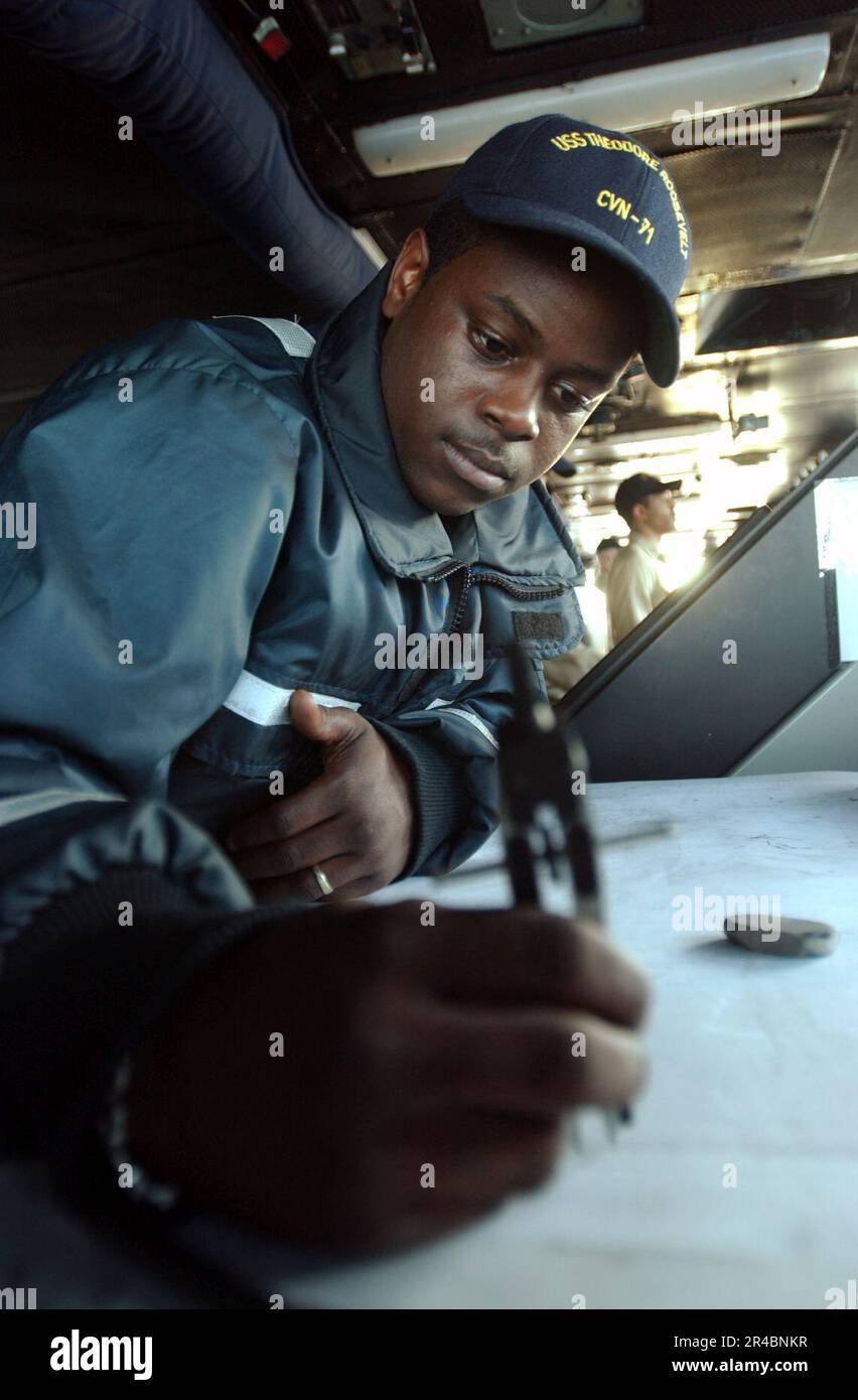 US Navy Quartermaster 3rd Class plots the ship's coordinates during ...