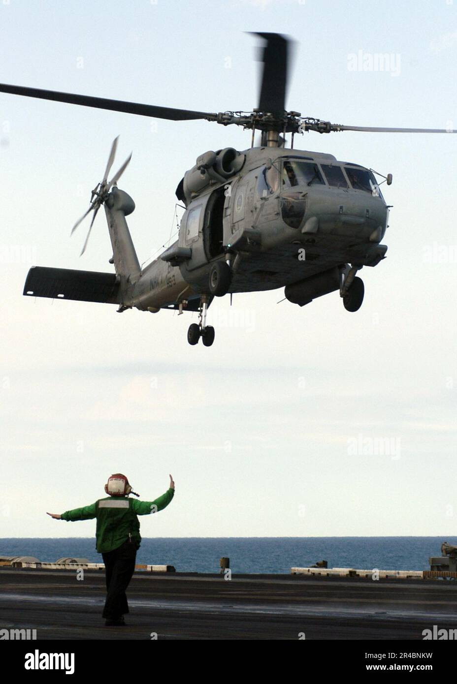US Navy A Landing Signal Enlisted directs an SH-60F Seahawk helicopter ...