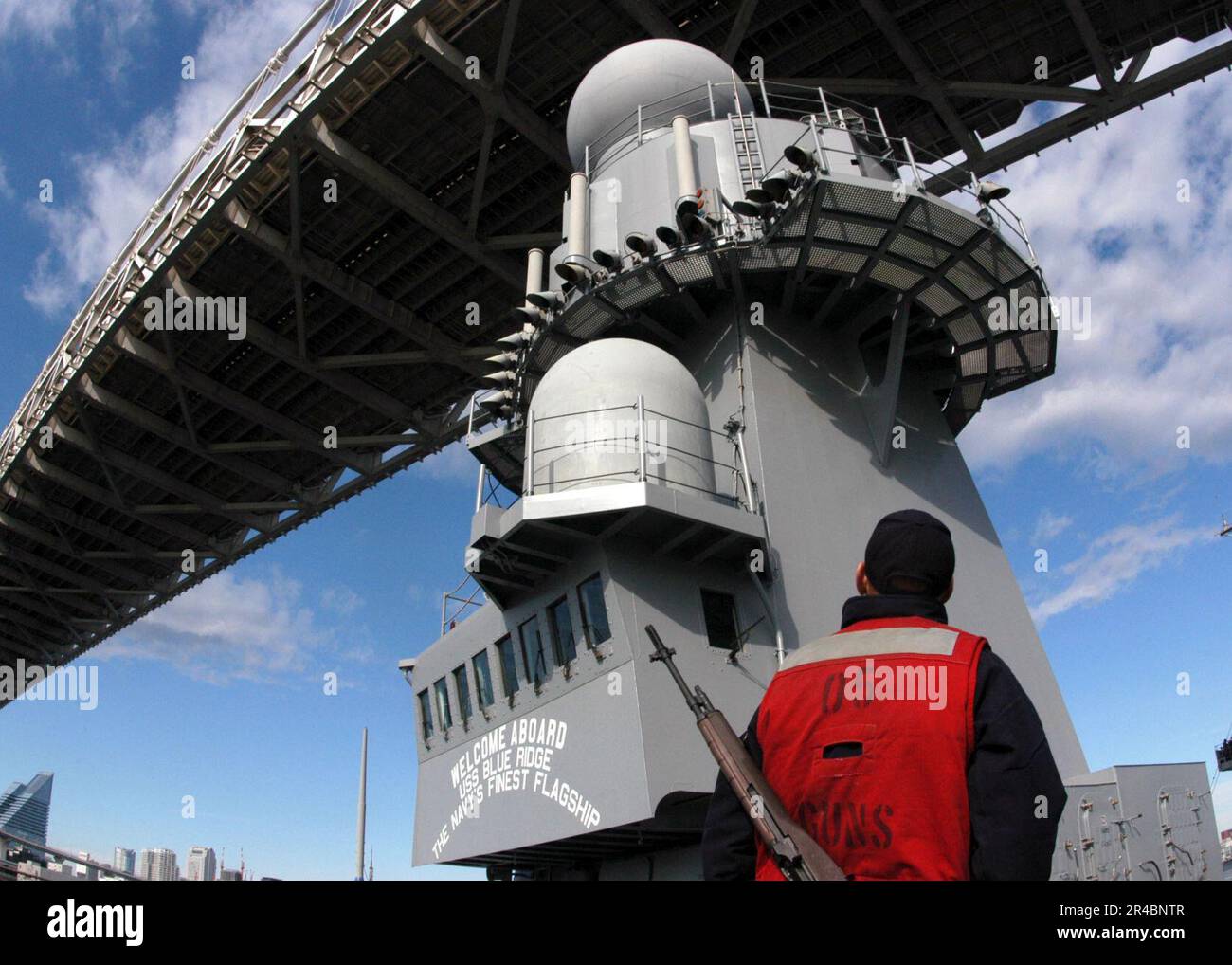 US Navy Gunner's Mate Seaman watches as amphibious command ship USS ...
