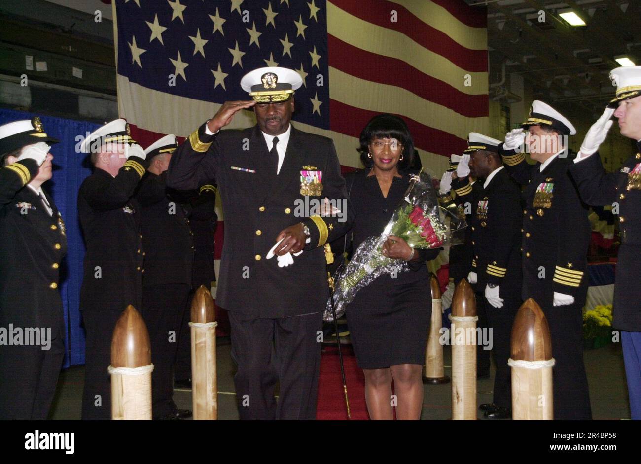 US Navy Rear Adm. Ruebin B. Bookert, accompanied by his wife renders ...