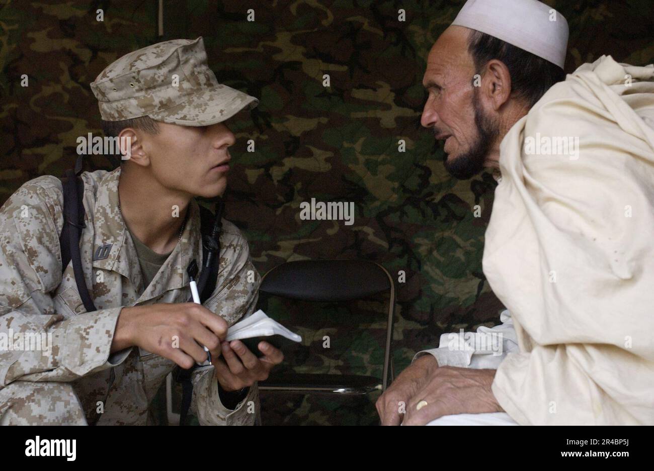 US Navy U.S. Navy Hospitalman left, gathers information from a patient ...