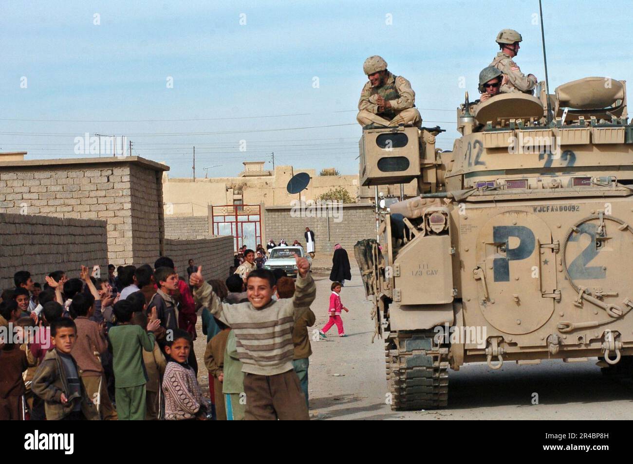 US Navy Iraqi children in Khan as Sur, Iraq, gather around a U.S. Army ...