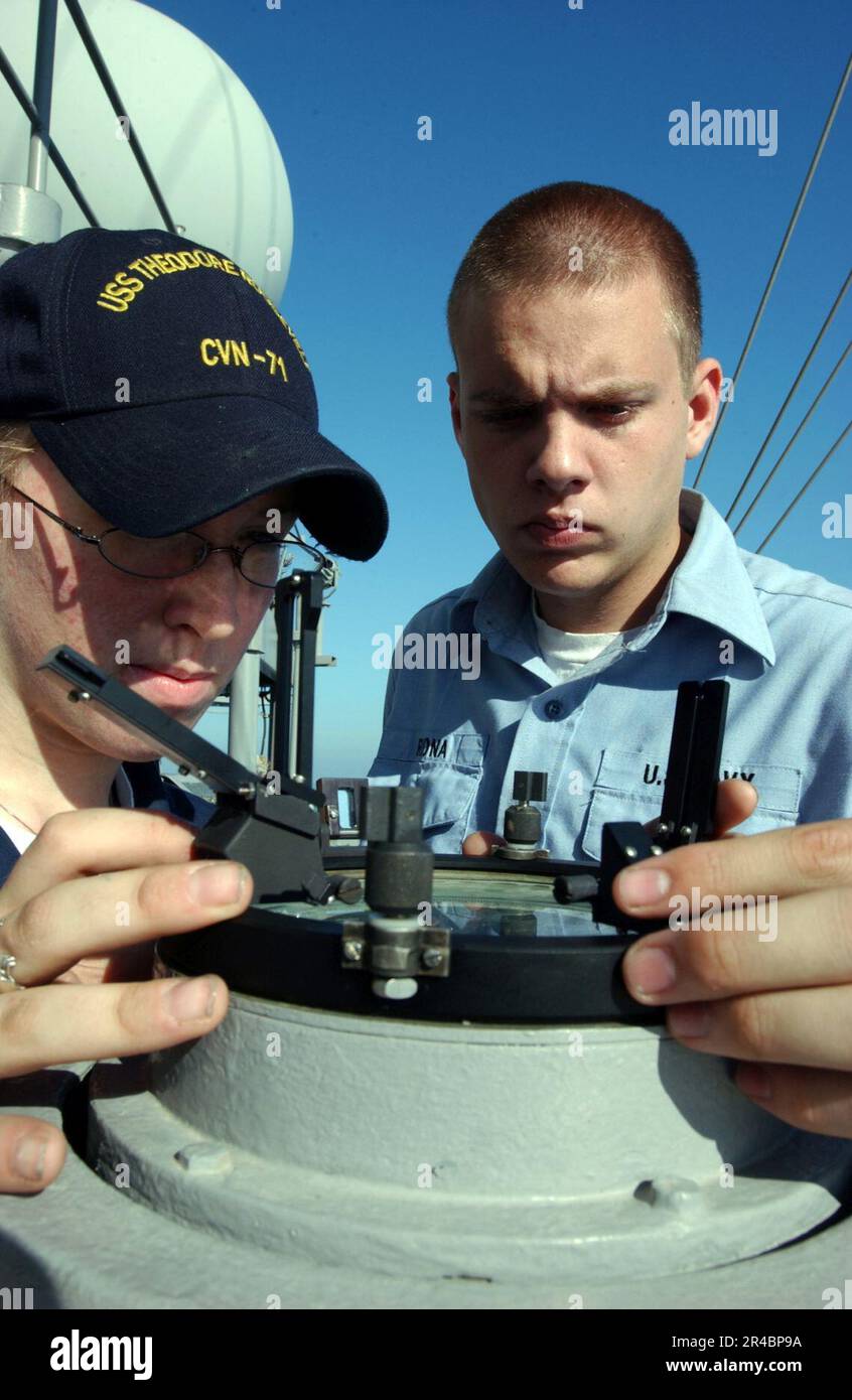 US Navy Quartermaster Seaman left, and Seaman shoot the azimuth of the ...