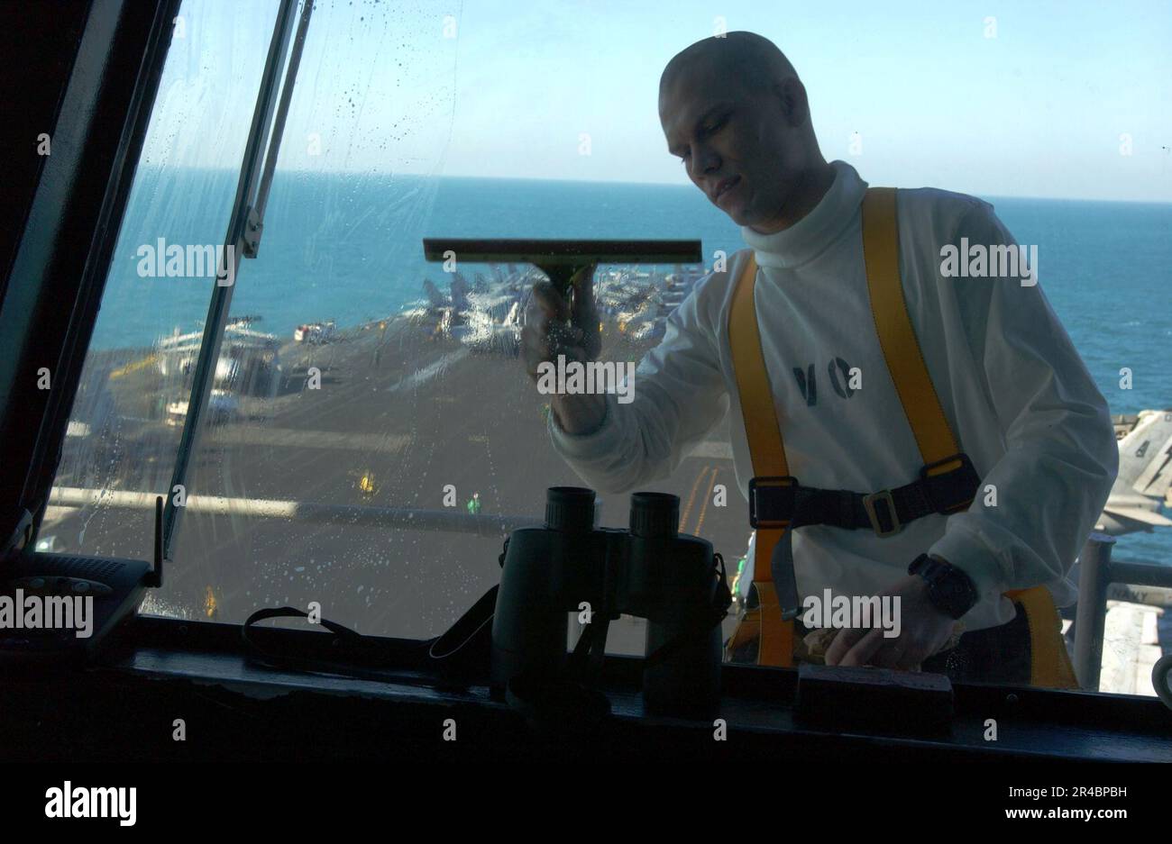 US Navy Aviation Boatswain's Mate Handler 2nd Class cleans the windows ...