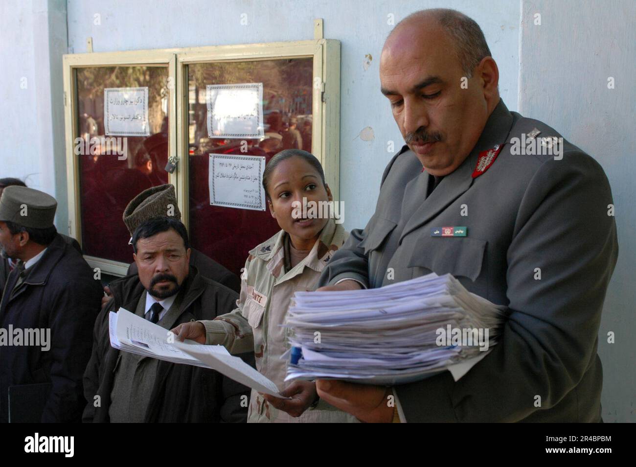US Navy U.S. Navy Petty Officer 1st Class center, assists Afghan ...