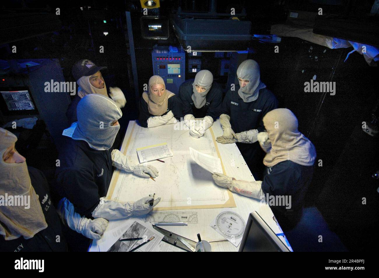 US Navy Combat Direction Center (CDC) watch standers plot a chart ...