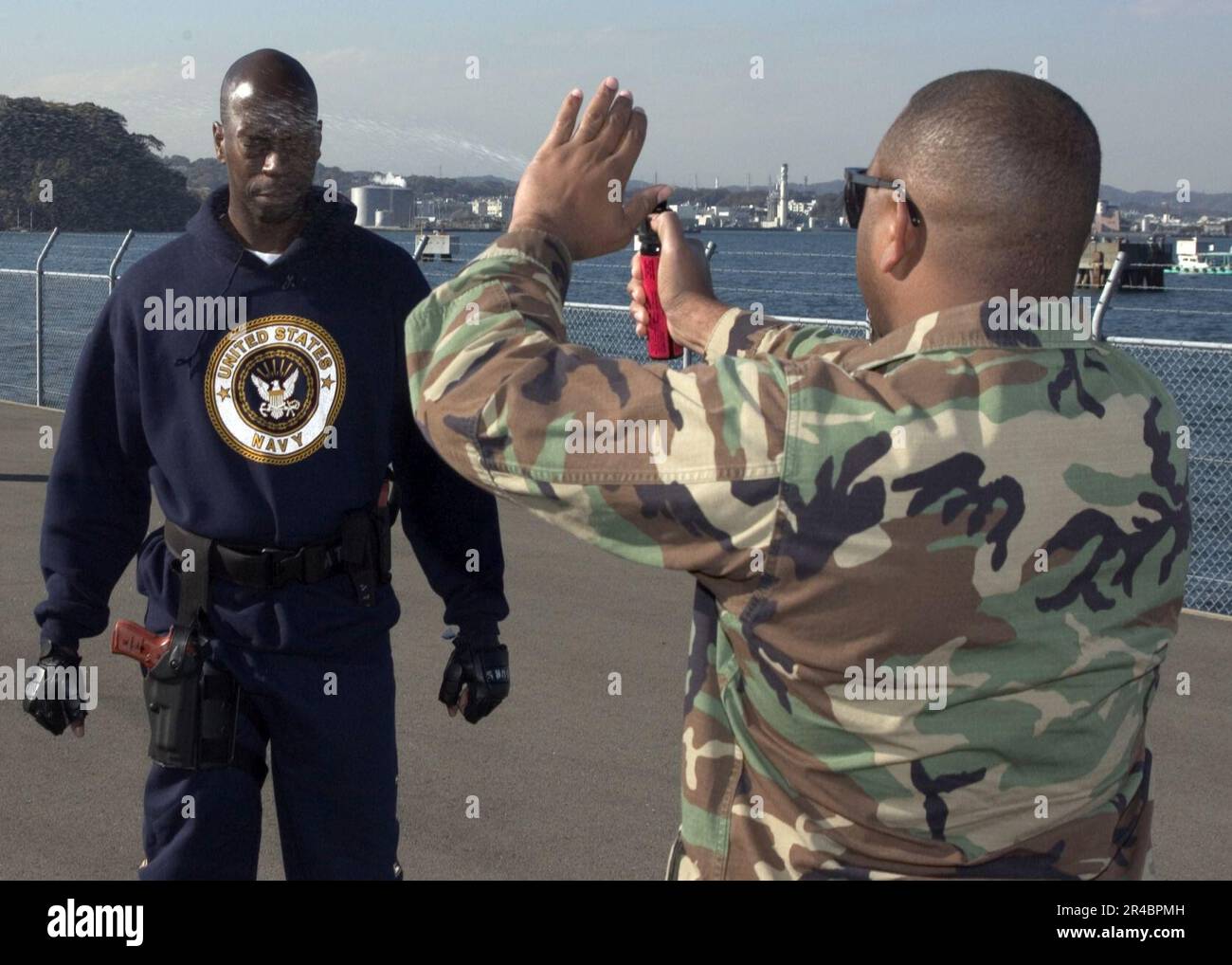 US Navy Electronics Technician 1st Class left, assigned to Afloat ...