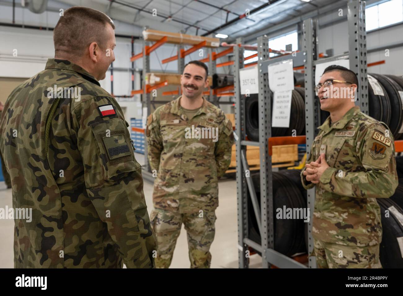 A Polish Infrastructure Team member talks to Airmen from the 99th ...