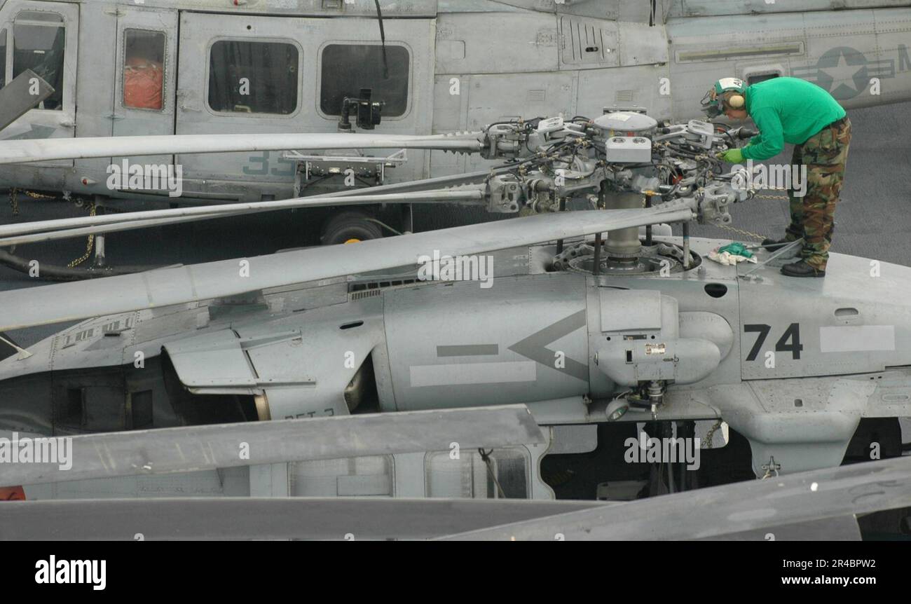 US Navy An Airman inspects the rotor head of a MH-60S Seahawk ...