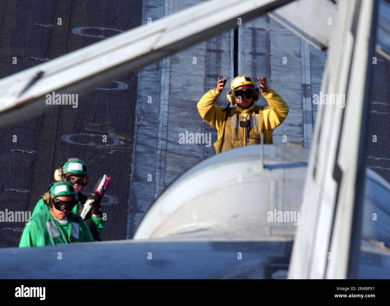 US Navy An aircraft director signals the pilot of an S-3B Viking to ...