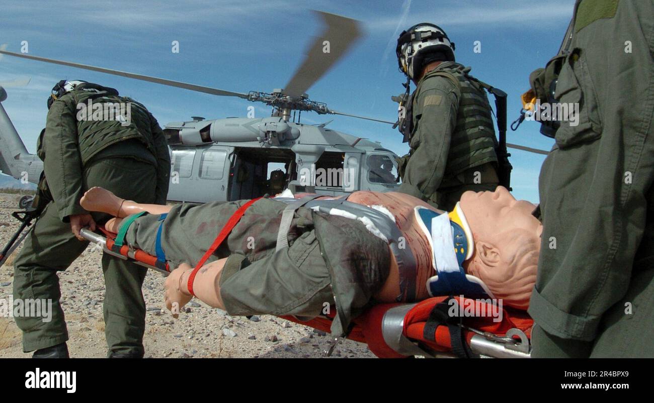 US Navy U.S. Navy air crewmen assigned to Helicopter Sea Combat Squadron Two One (HSC-21), carry ...